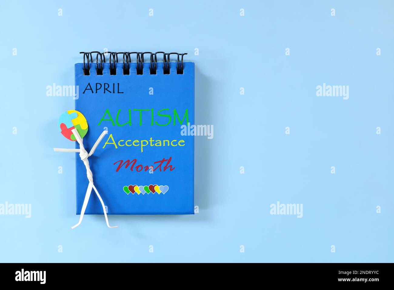April as Autism Acceptance Month reminder on blue desk calendar ...
