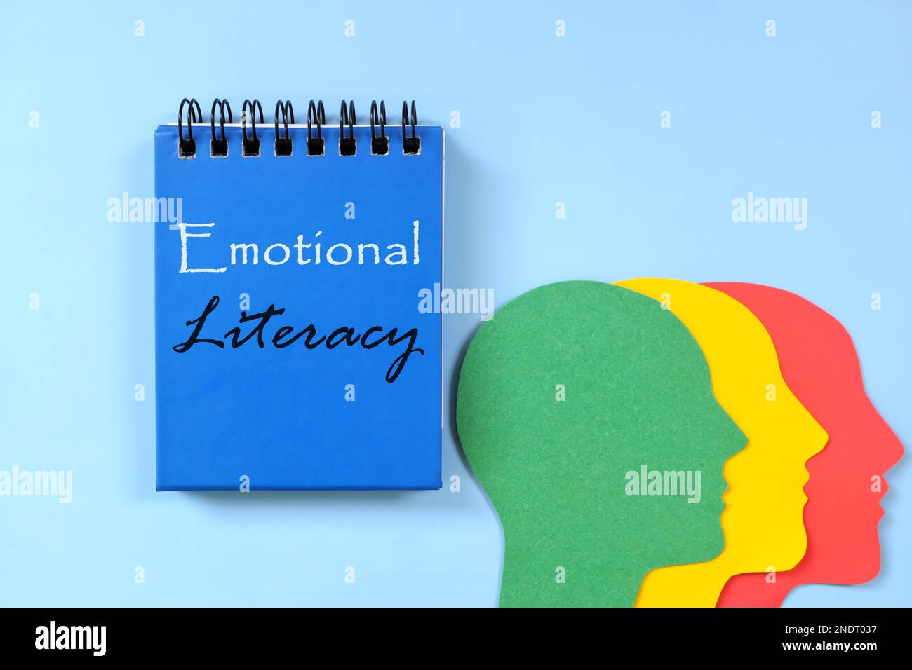 Emotional literacy concept. Word written on blue notepad with human ...
