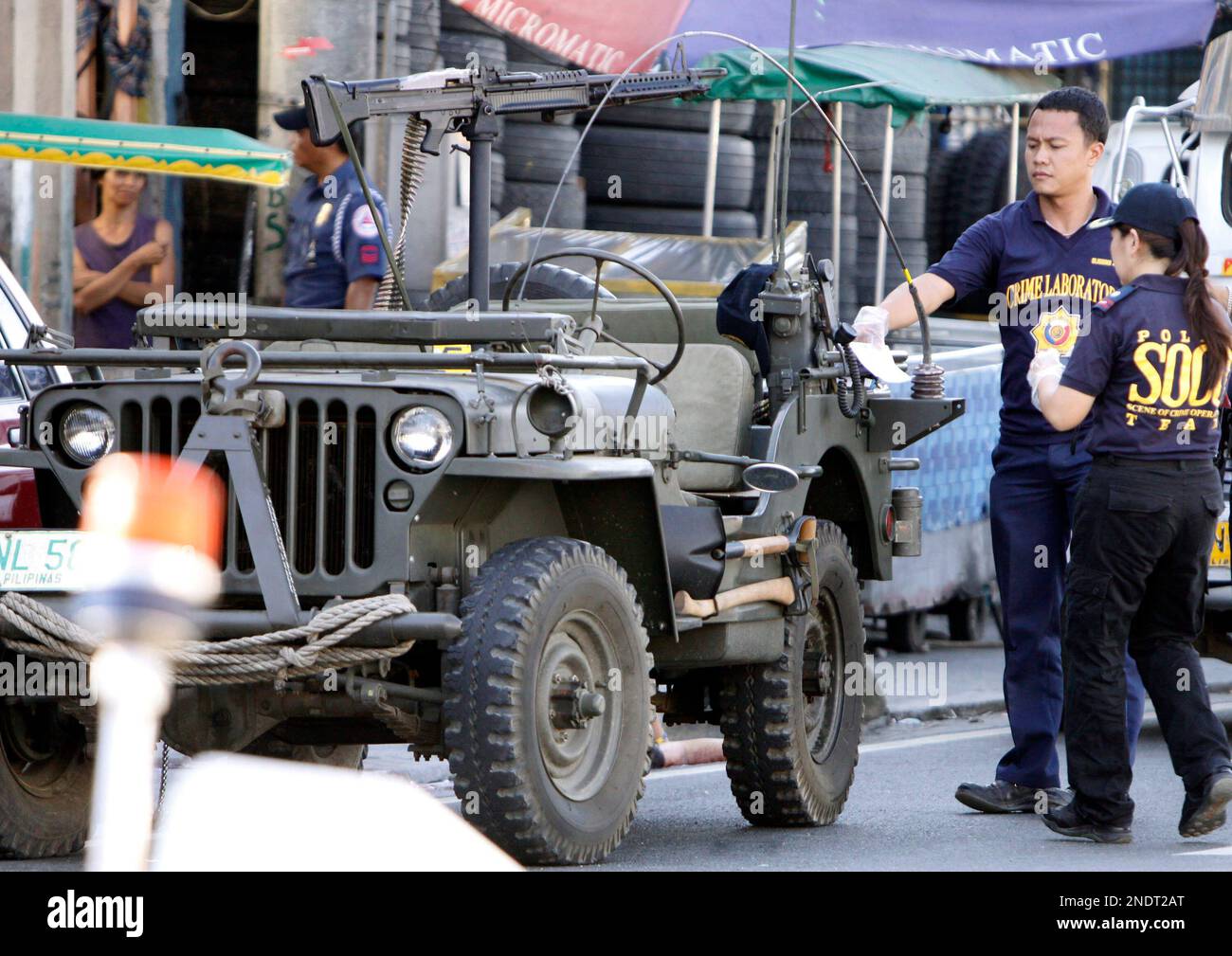 Crime scene investigators examine a vehicle mounted with an M60 machine ...