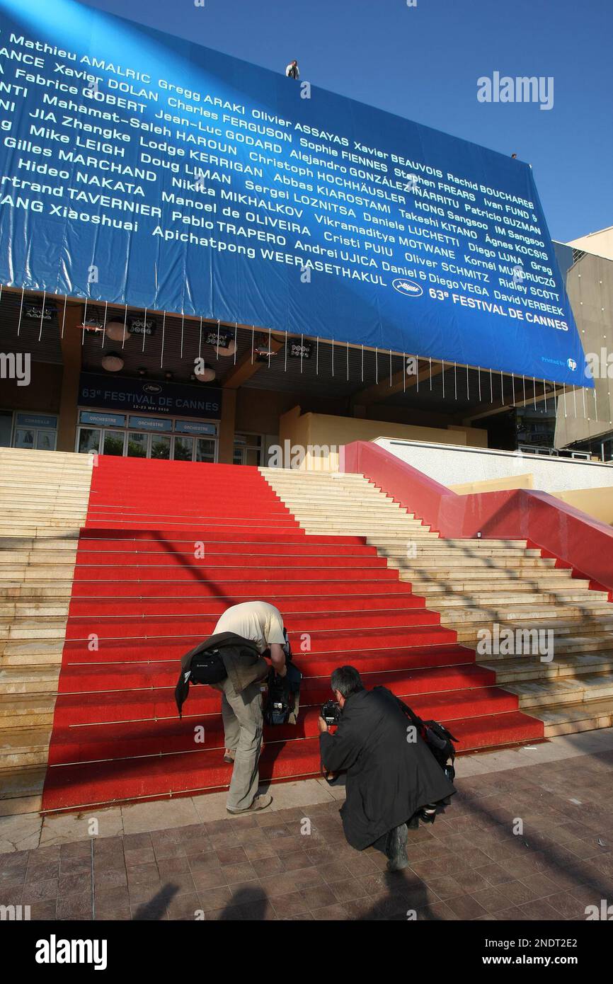 Photographer and cameraman take picture of a giant canvas of the 63rd ...