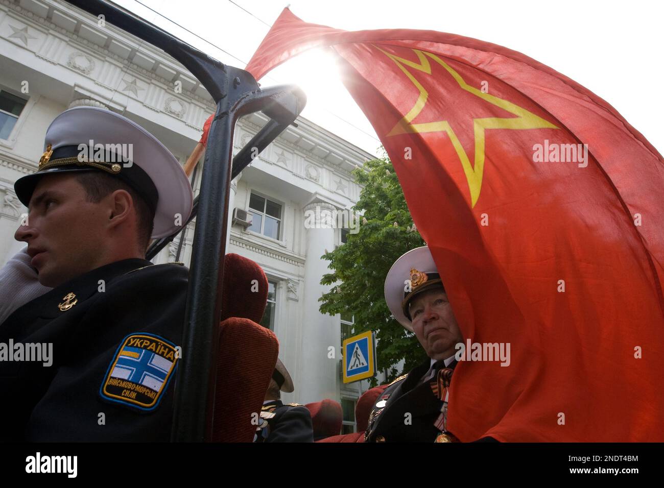 A seaman of the Ukrainian Navy, left, rides in a car with World War II ...