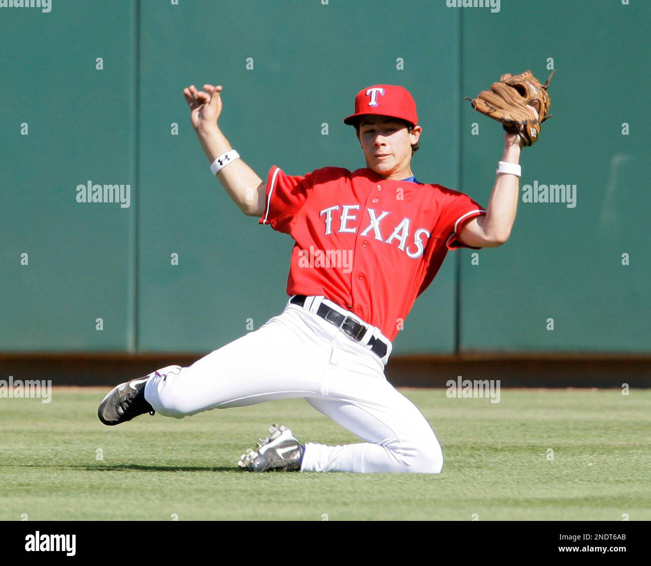 Entertainer Nick Jonas of the Jonas Brothers makes a sliding dive grab ...