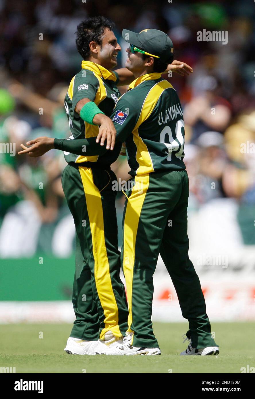 Pakistan's Abdur Rehman, left, and Umar Akmal celebrate the dismissal ...
