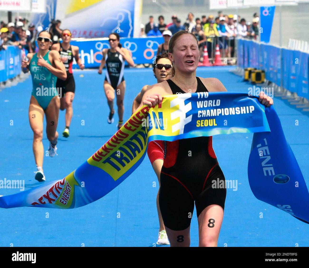 Switzerland's Daniela Ryf breaks the finish line as she wins the ITU ...