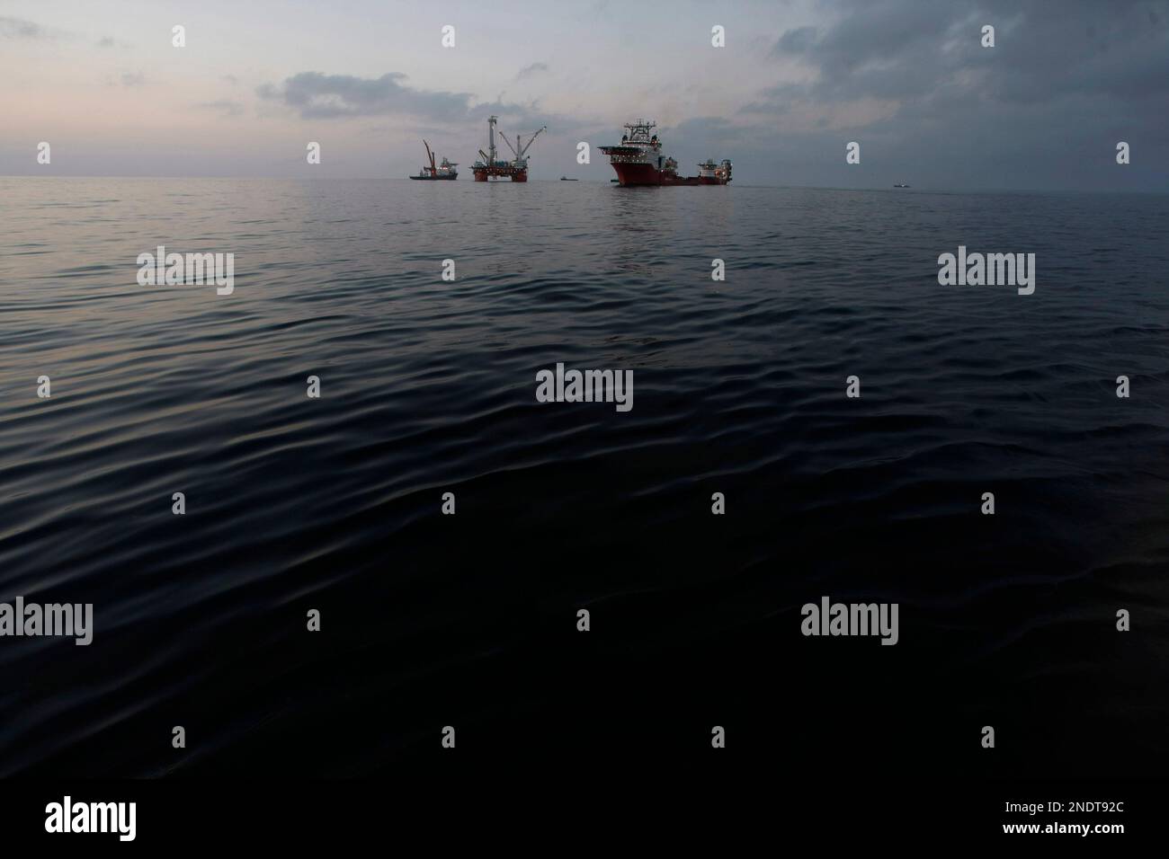 The Q4000, center, which has lowered the oil containment vessel to the ...