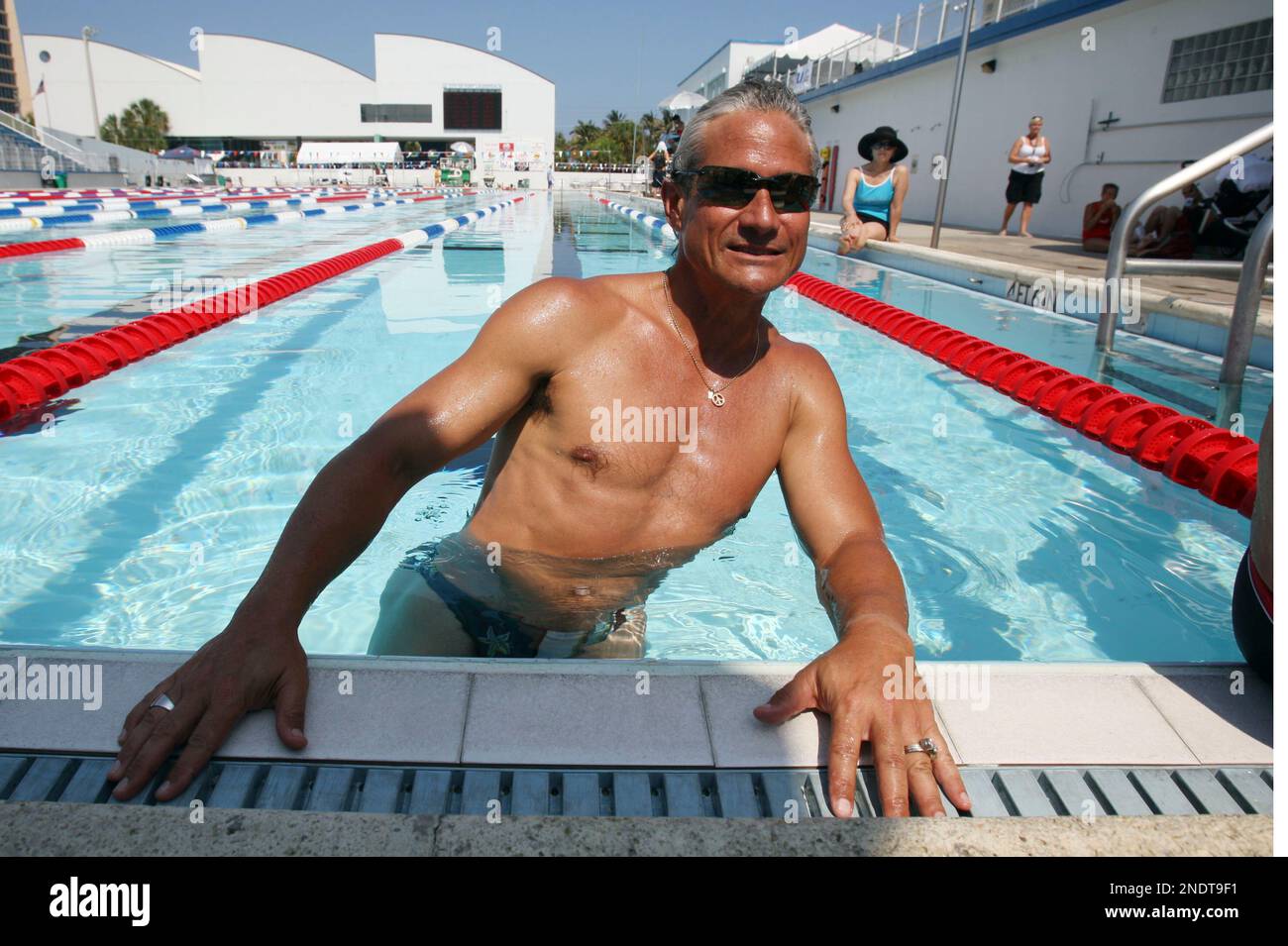 Four-time Olympic gold medalist Greg Louganis stretches as he cools off ...