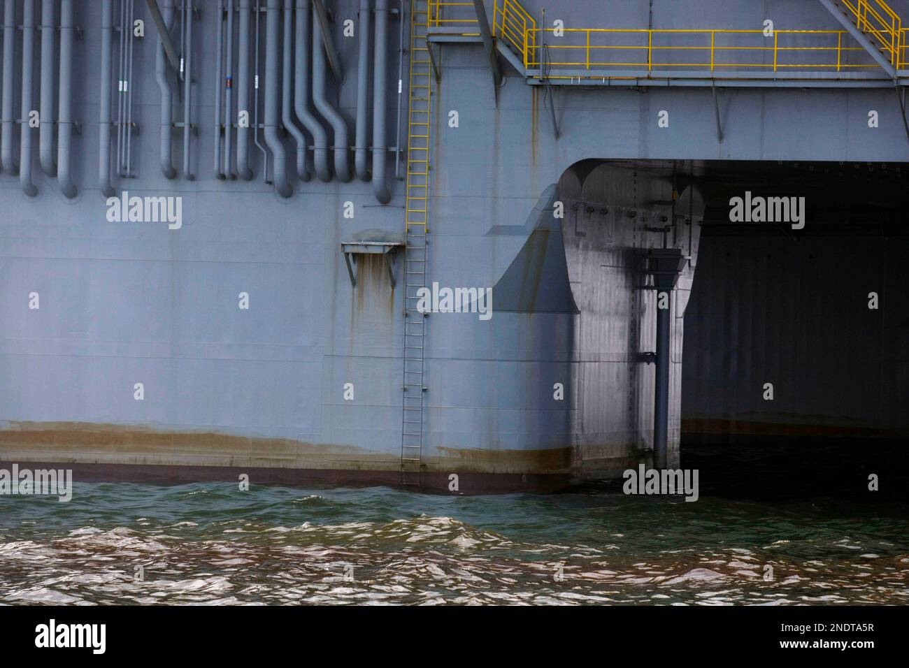 Oil from the oil slick is seen smeared at the waterline of the ...