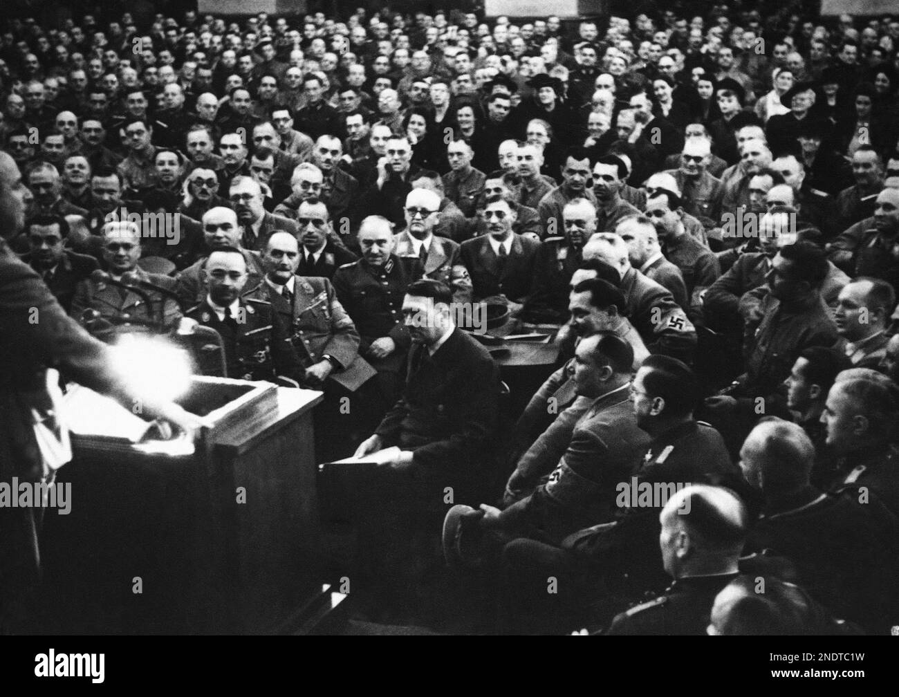 German Chancellor Adolf Hitler, centre, listens to a speech of welcome ...