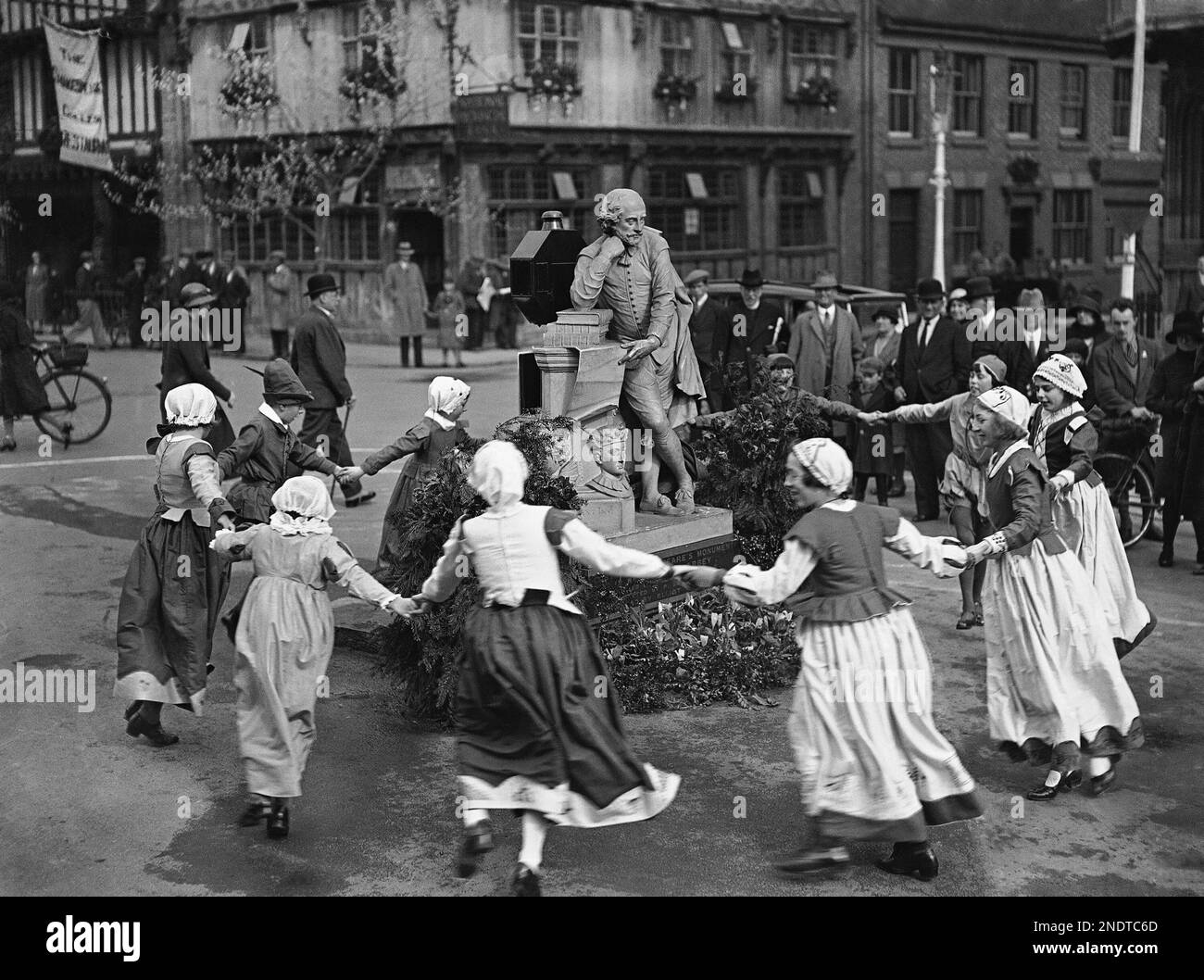 Children dance around the Shakespeare Memorial Statue in Stratford-upon ...