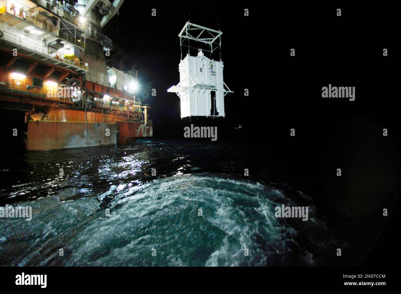 The containment vessel is lowered into the Gulf of Mexico at the site ...