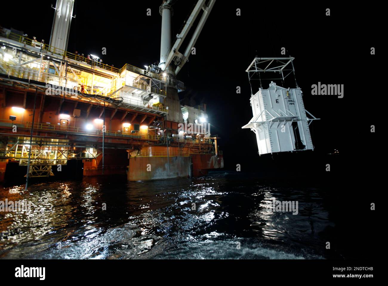 The containment vessel is lowered into the Gulf of Mexico at the site ...