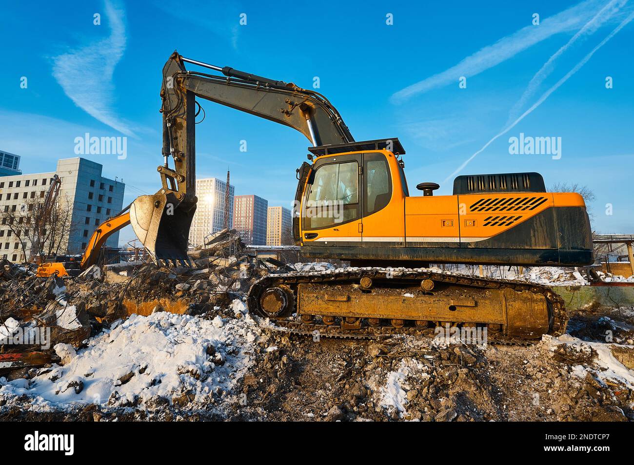 Bucket on excavator collects construction debris on site Stock Photo ...