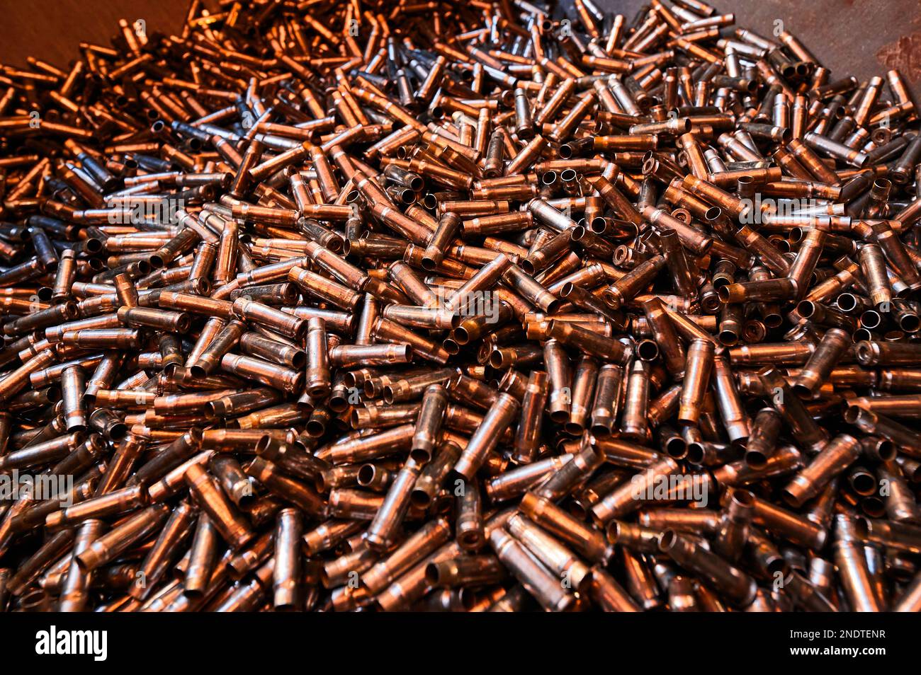 Bullet casings pile in weapon production plant storage Stock Photo - Alamy