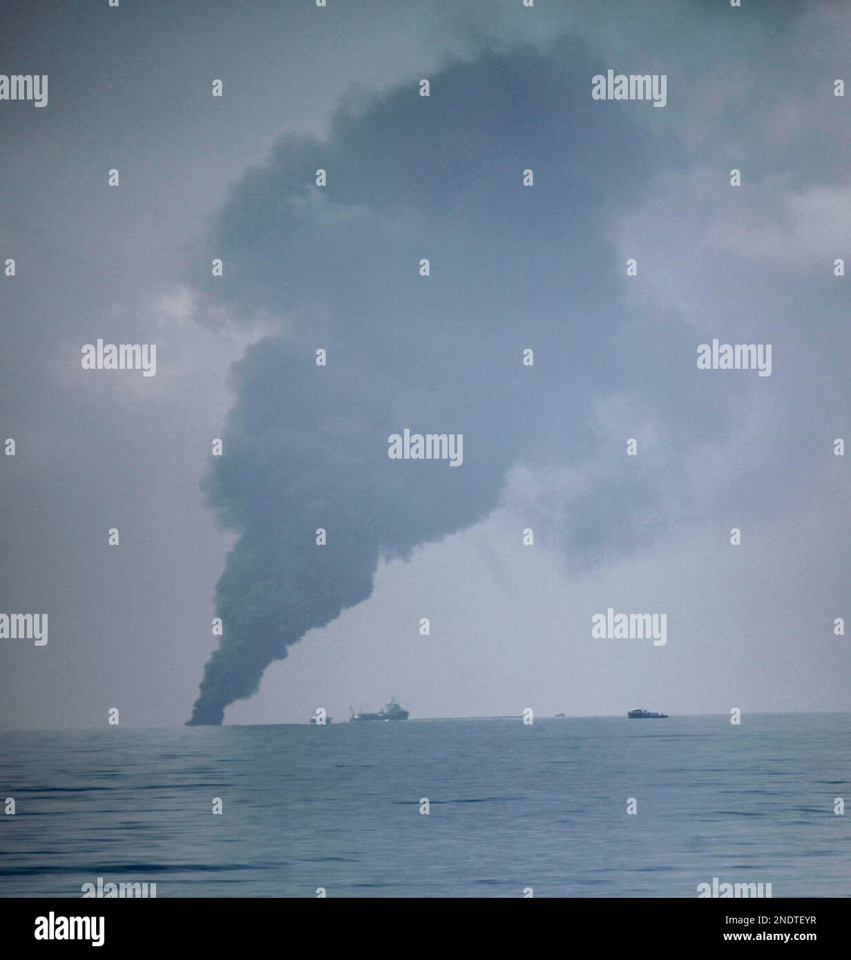 A plume of smoke is seen from a controlled oil burn, from the deck of ...