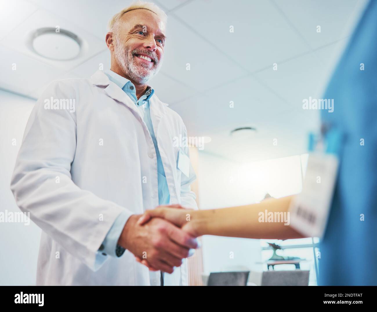 Healthcare, handshake and doctor in partnership with a nurse for a ...