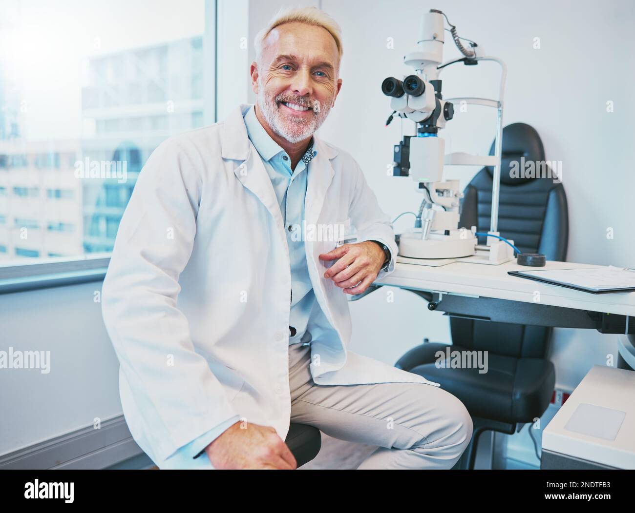 Optometry, healthcare and portrait of a male optometrist sitting by ...
