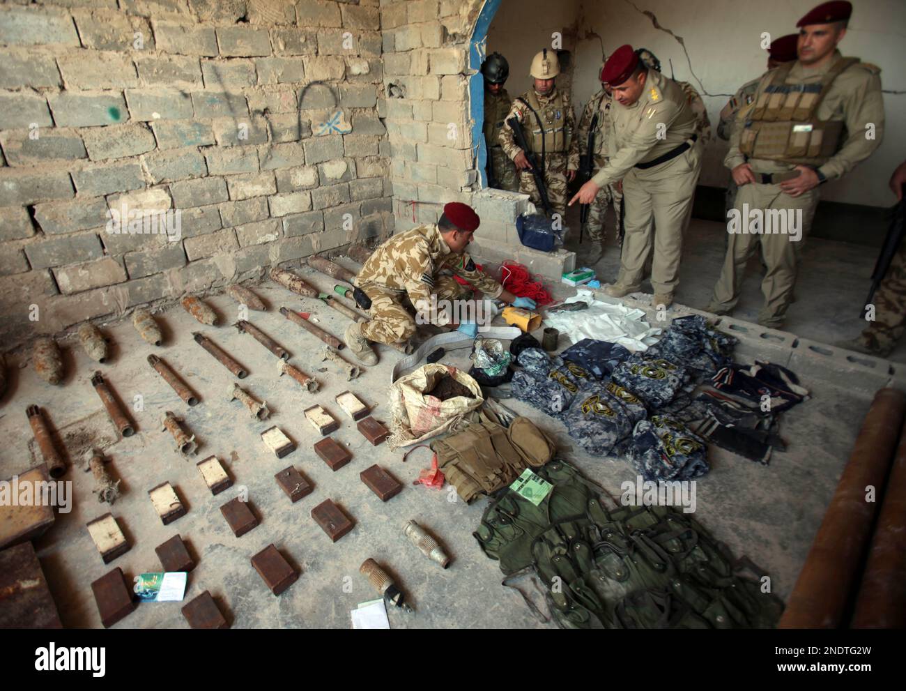 Iraqi Army soldiers check weapons seized by Iraqi security forces ...