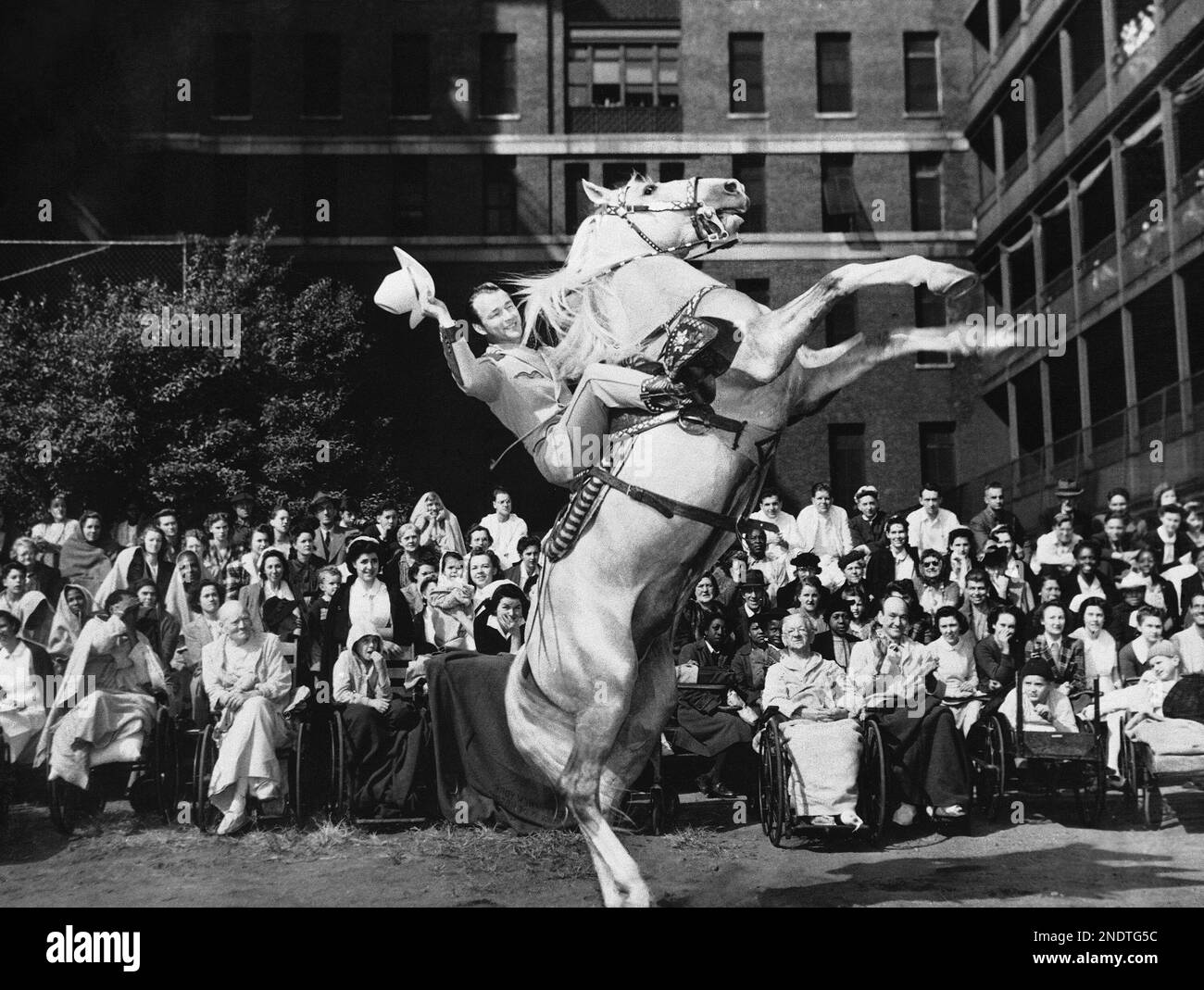 Roy Rogers, featured performer of the Rodeo, stunts with his horse ...