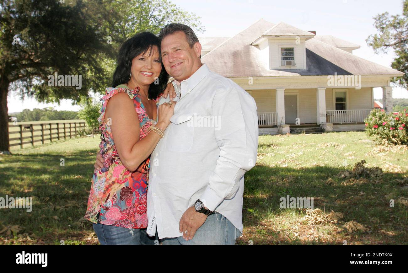 Beverly Lambert, left, and husband Rick Lambert stand in front of their old house in Lindale ...