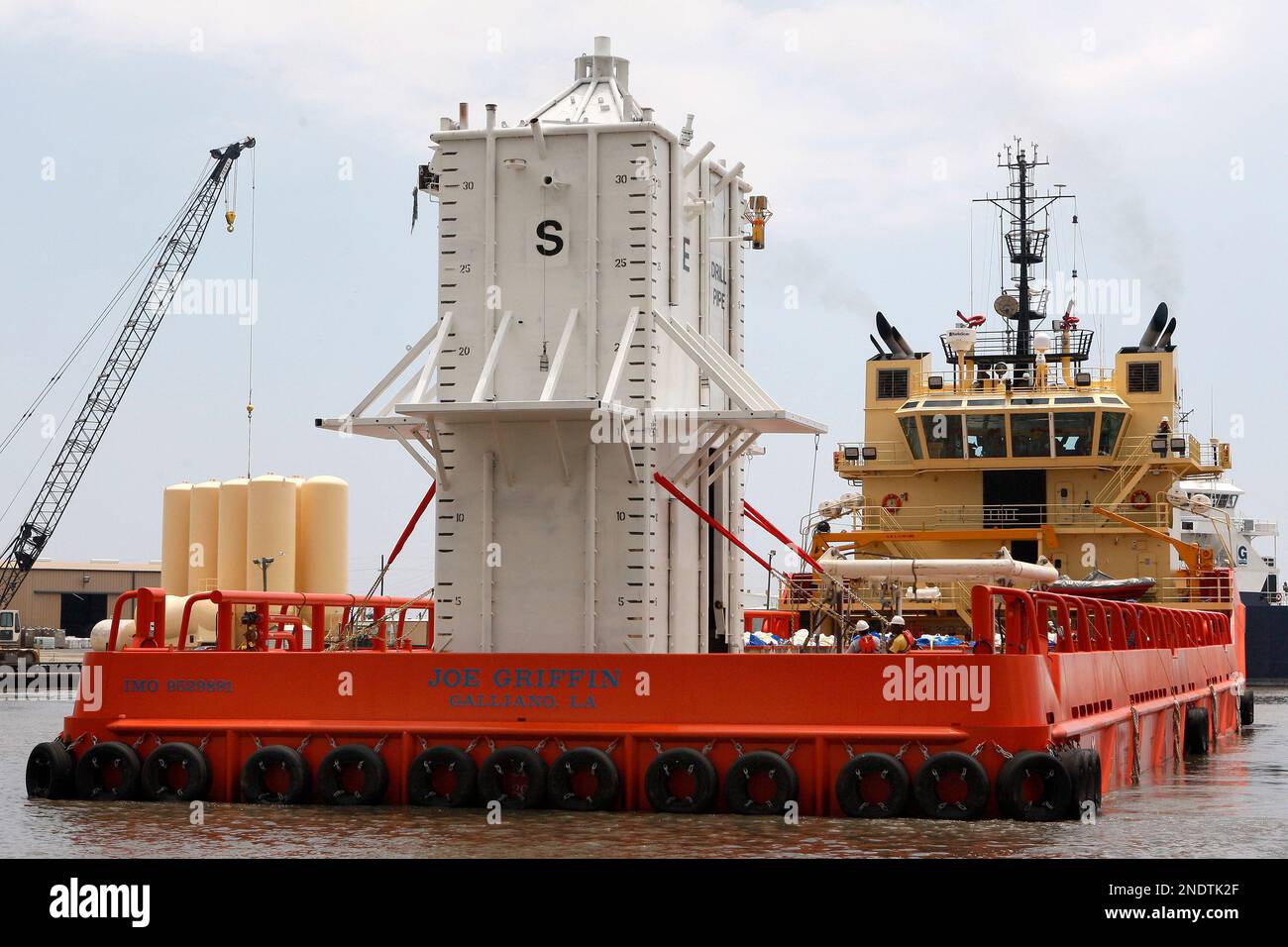 The barge Joe Griffin turns around in a channel after a crane loaded a ...