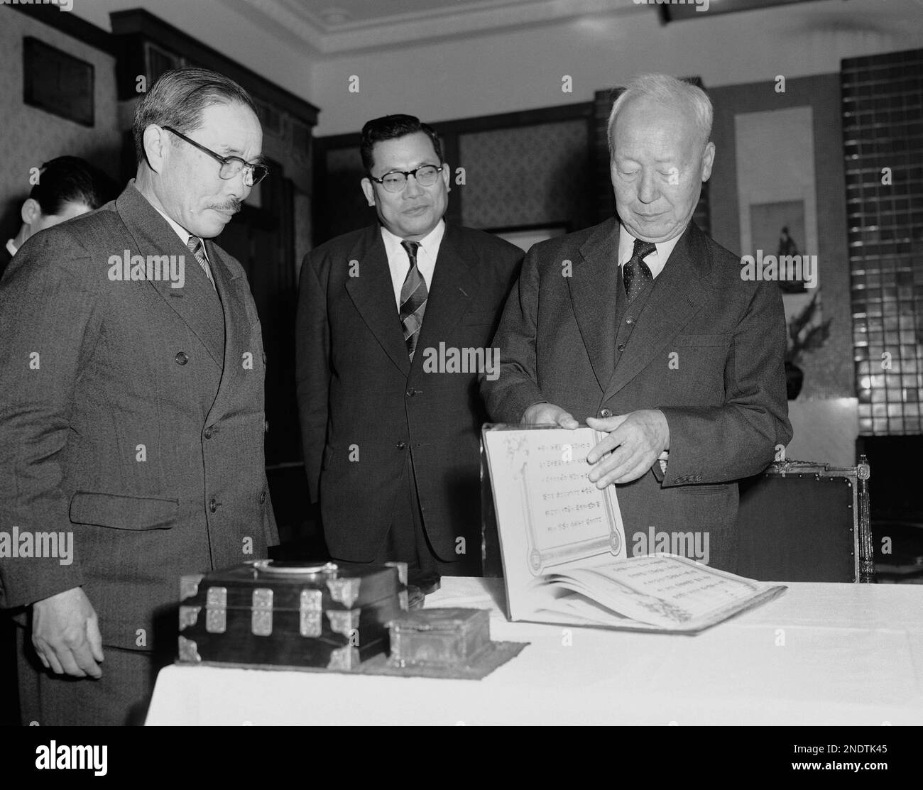 South Korean President Syngman Rhee leafs through the mutual defense ...