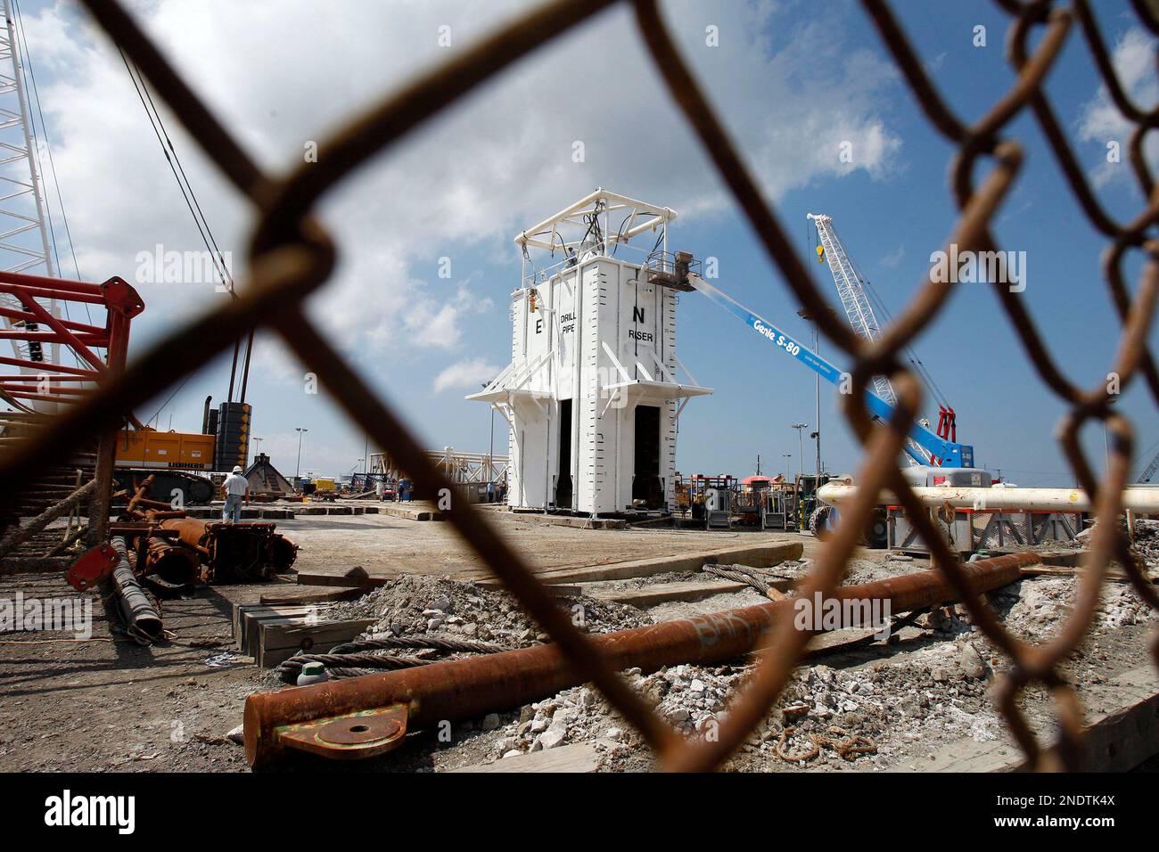 Workers at the Wild Well Control company work on a chamber that will be ...