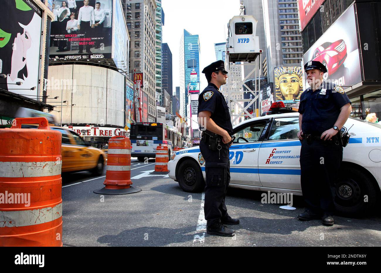 Two New York City police officers stand near a police lookout post ...