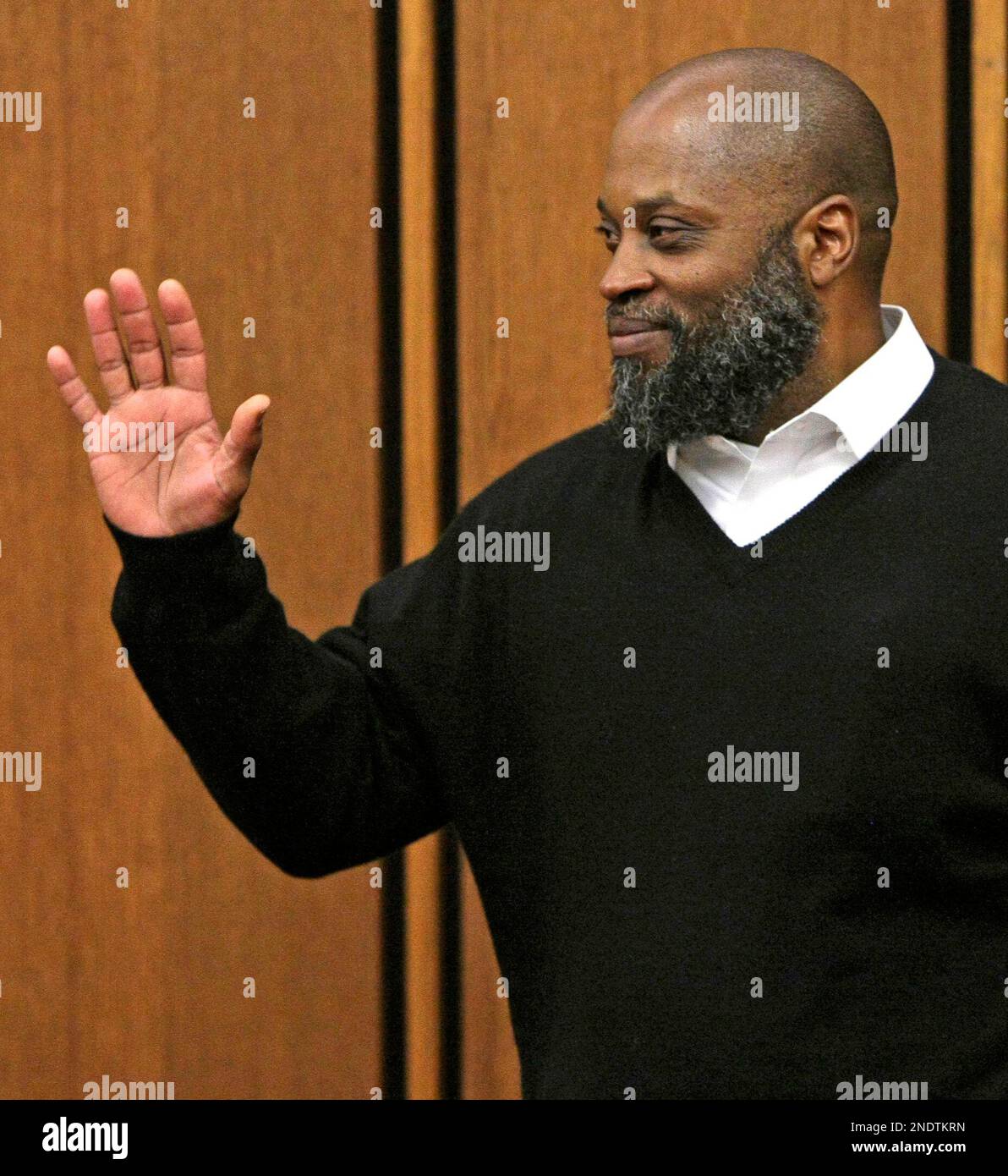 Raymond Towler waves to family members as he enters the courtroom ...