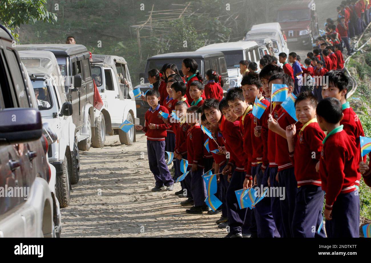 School children hold Naga flags as they cheer the arrival of National ...