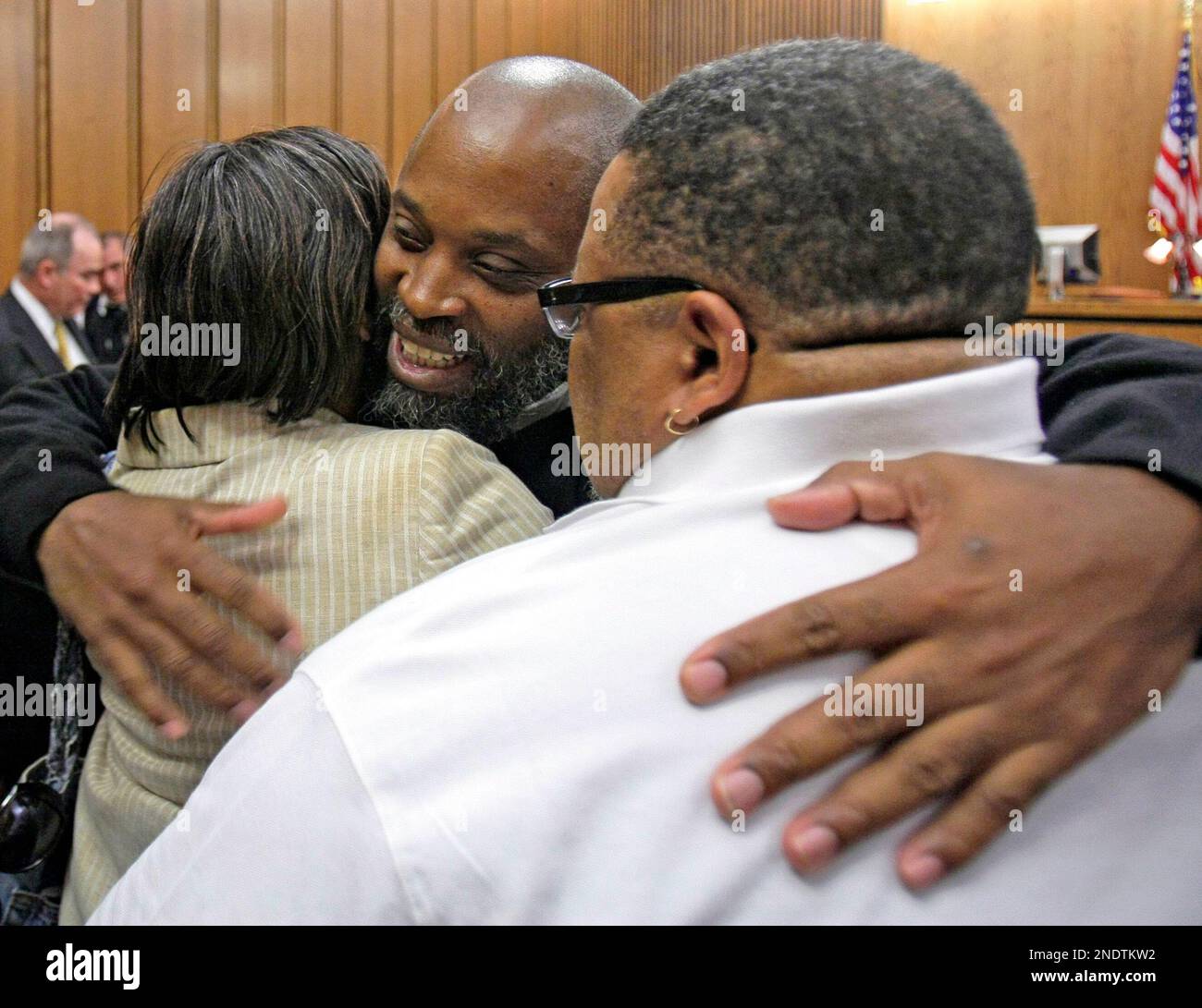 Raymond Towler, center, hugs his sister Debbie Settles, left, and his ...