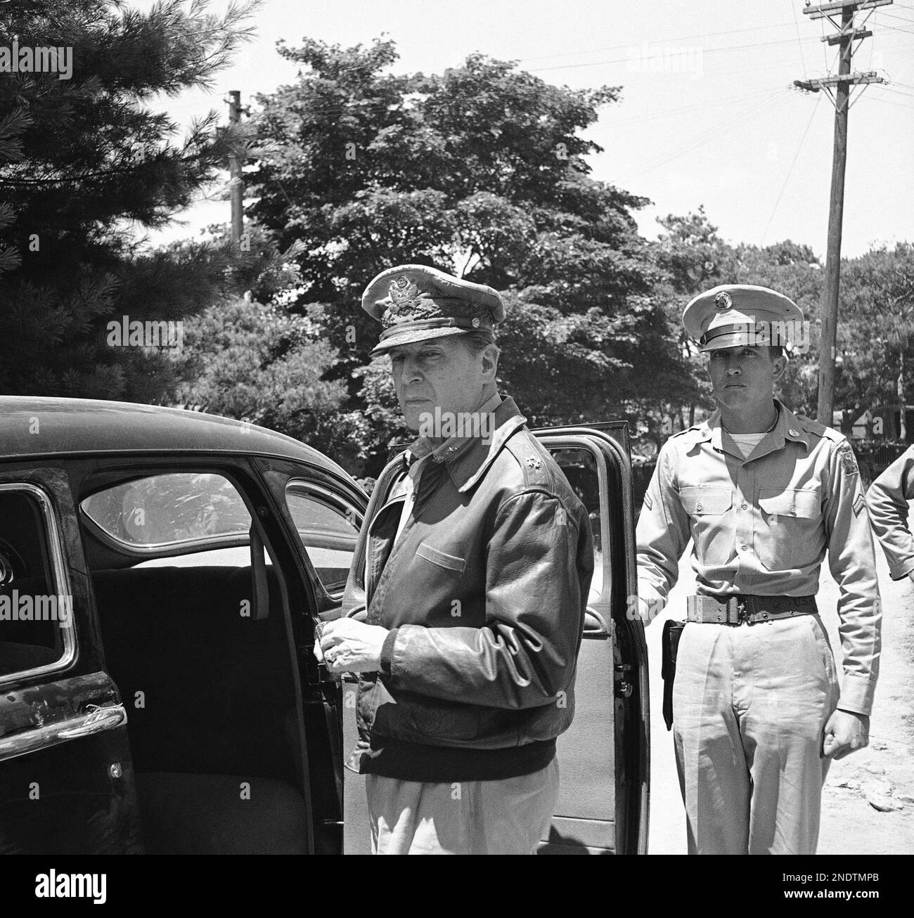 Gen. Douglas MacArthur gets on a dusty sedan for his advanced ...