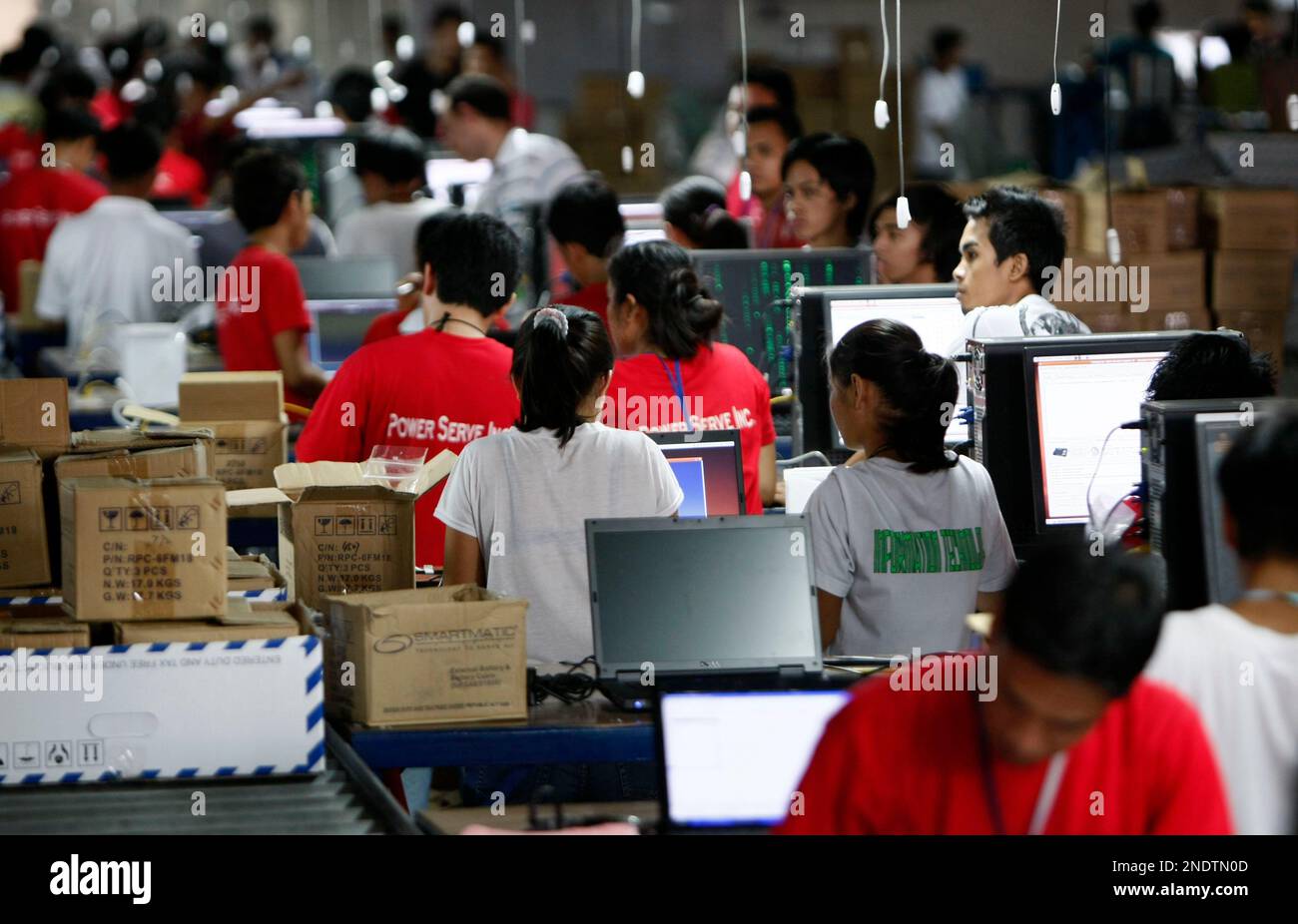 Workers check the PCOS (Precinct Count Optical Scan) machines as they ...