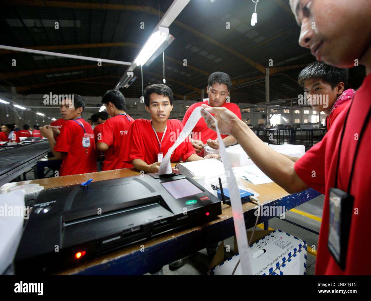 A worker checks the print out from the PCOS (Precinct Count Optical ...
