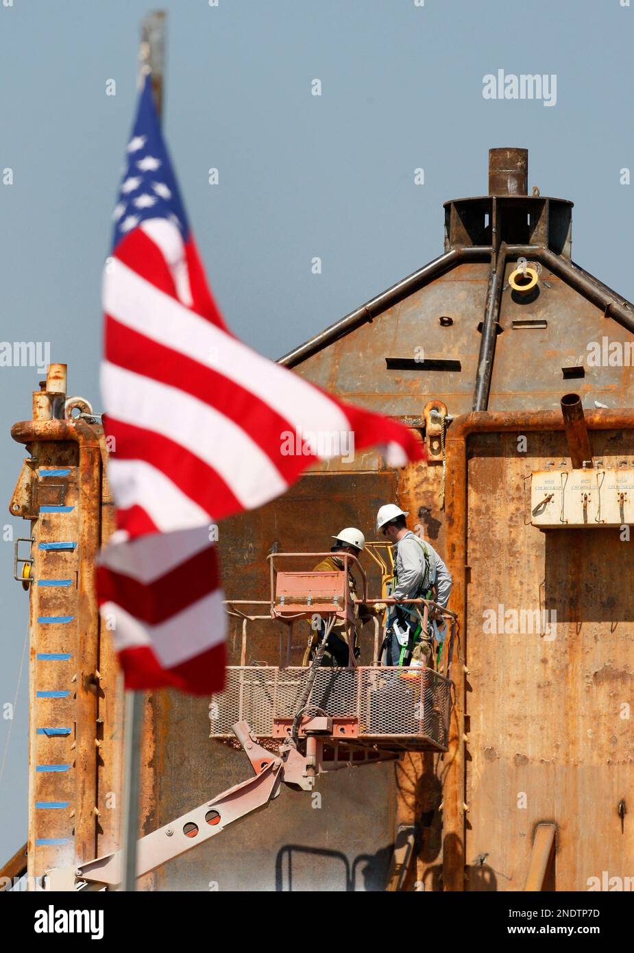Workers at the Wild Well Control company work on a chamber that will be ...