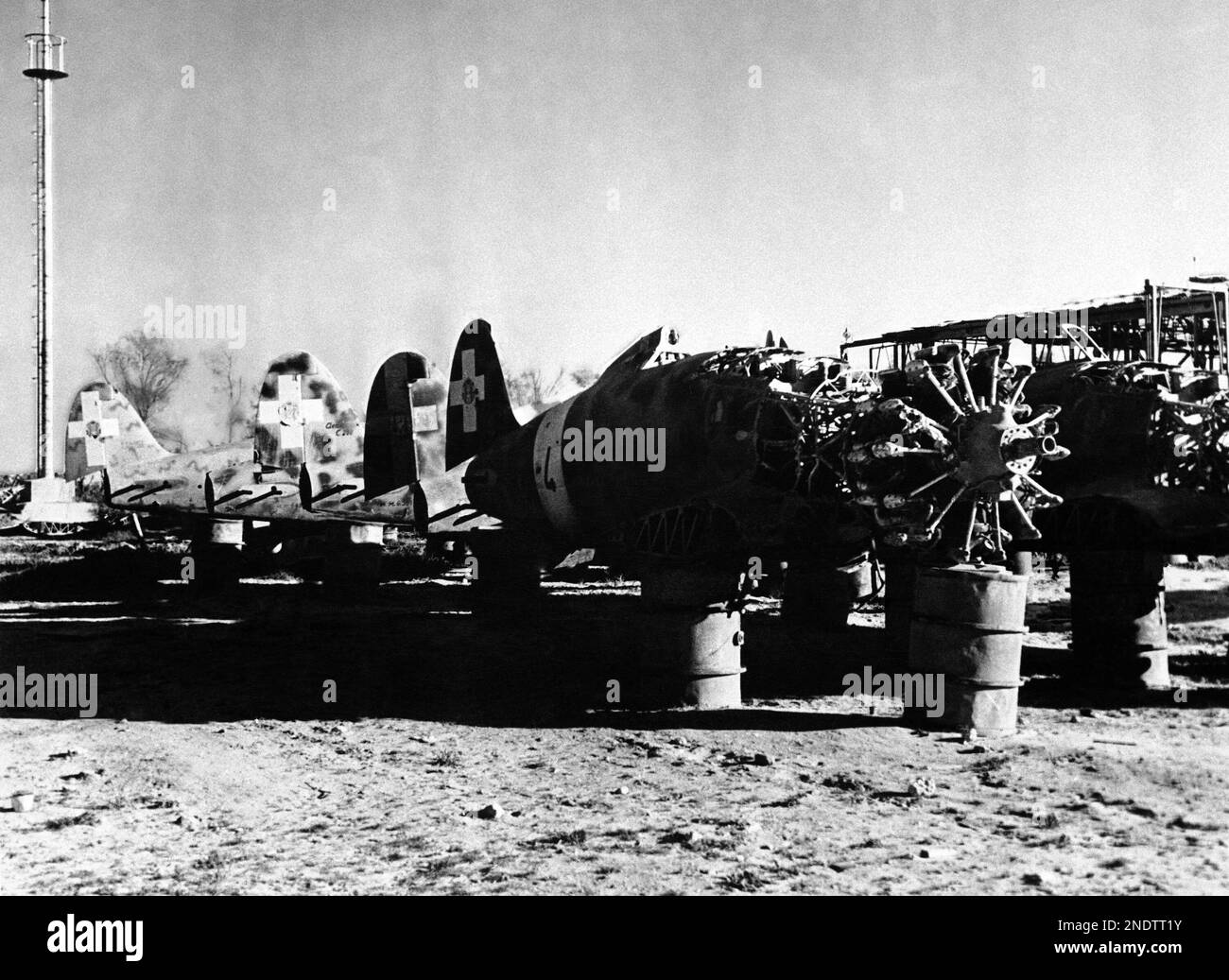 Some Italian fighter planes, without wings, and propellers, propped up ...
