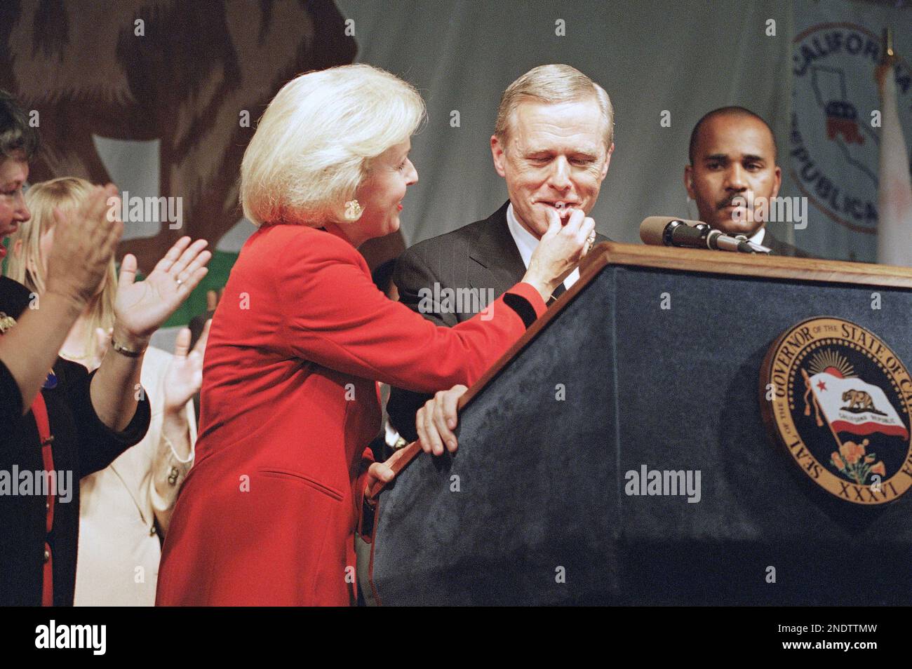 Gayle Wilson removes lipstick from the face of her husband Pete Wilson ...