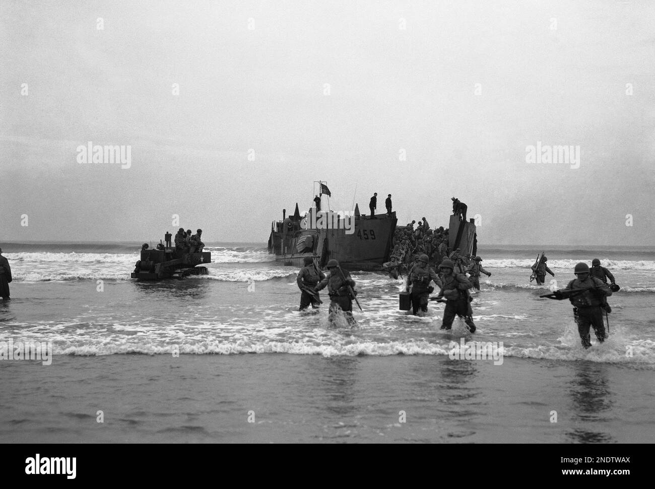 U.S. assault troops and equipment, bulldozers, lorries and jeeps coming ...