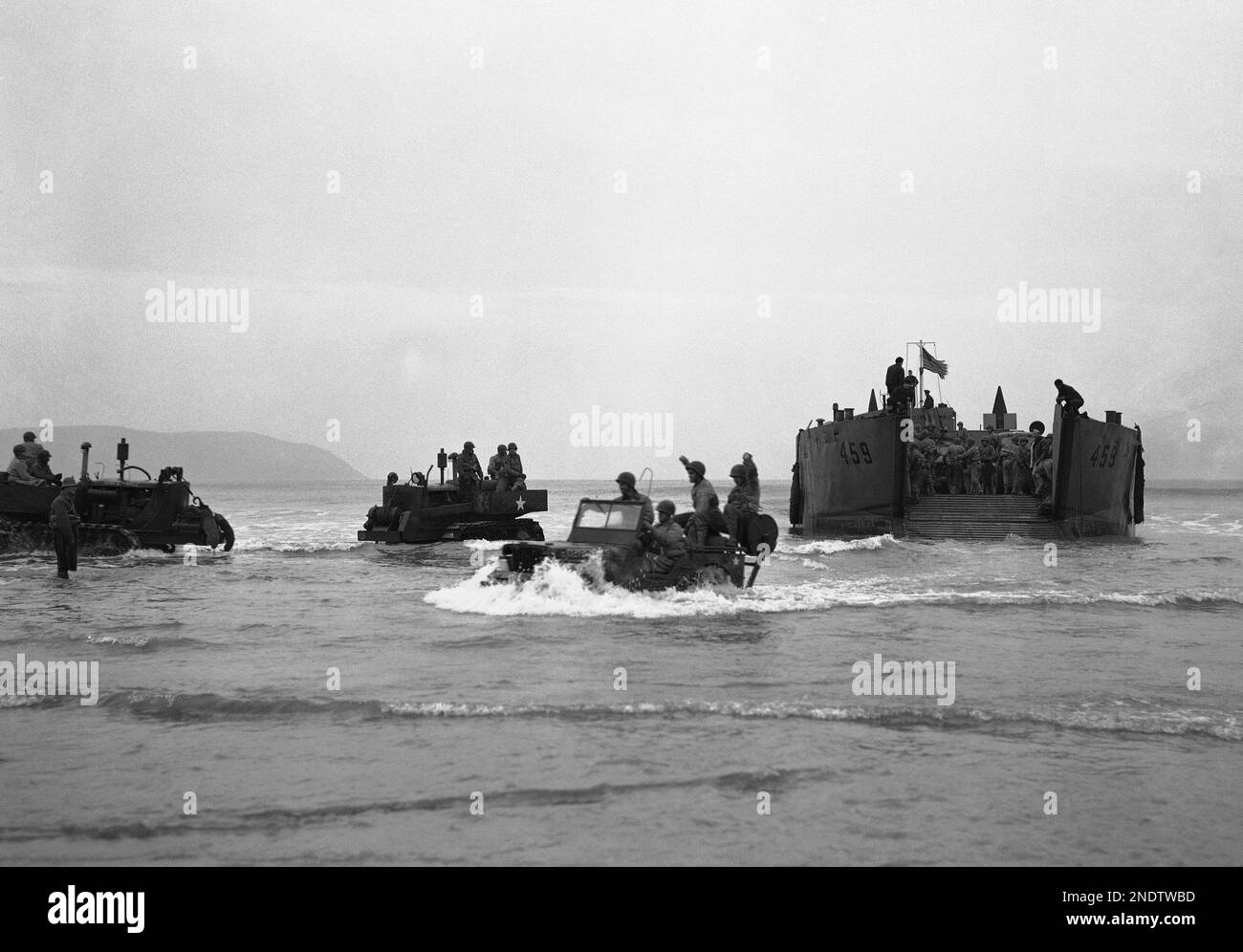 U.S. assault troops and equipment, bulldozers, lorries and jeeps coming ...