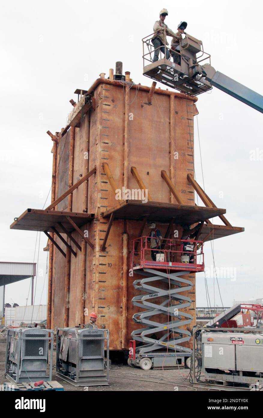 Workers at the Wild Well Control company work on a containment chamber ...