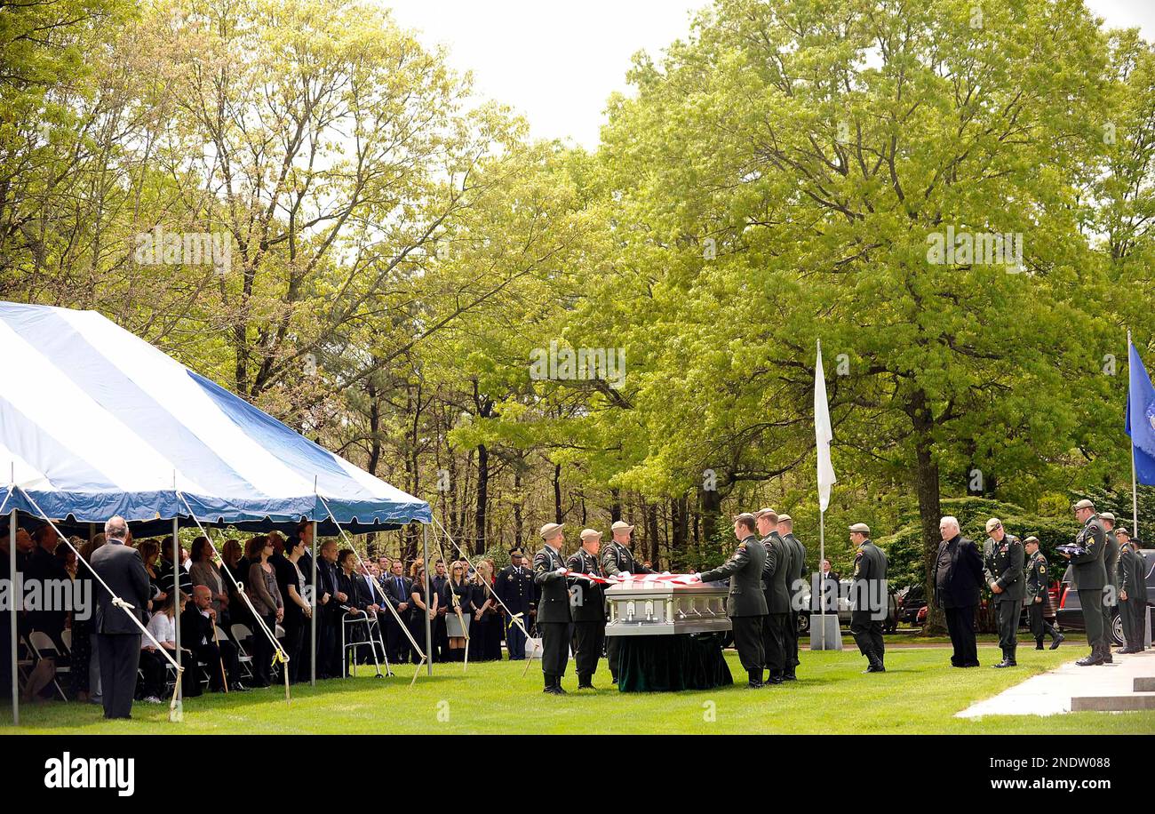 A military honor guard places the casket of U.S. Army Sgt. Jason ...