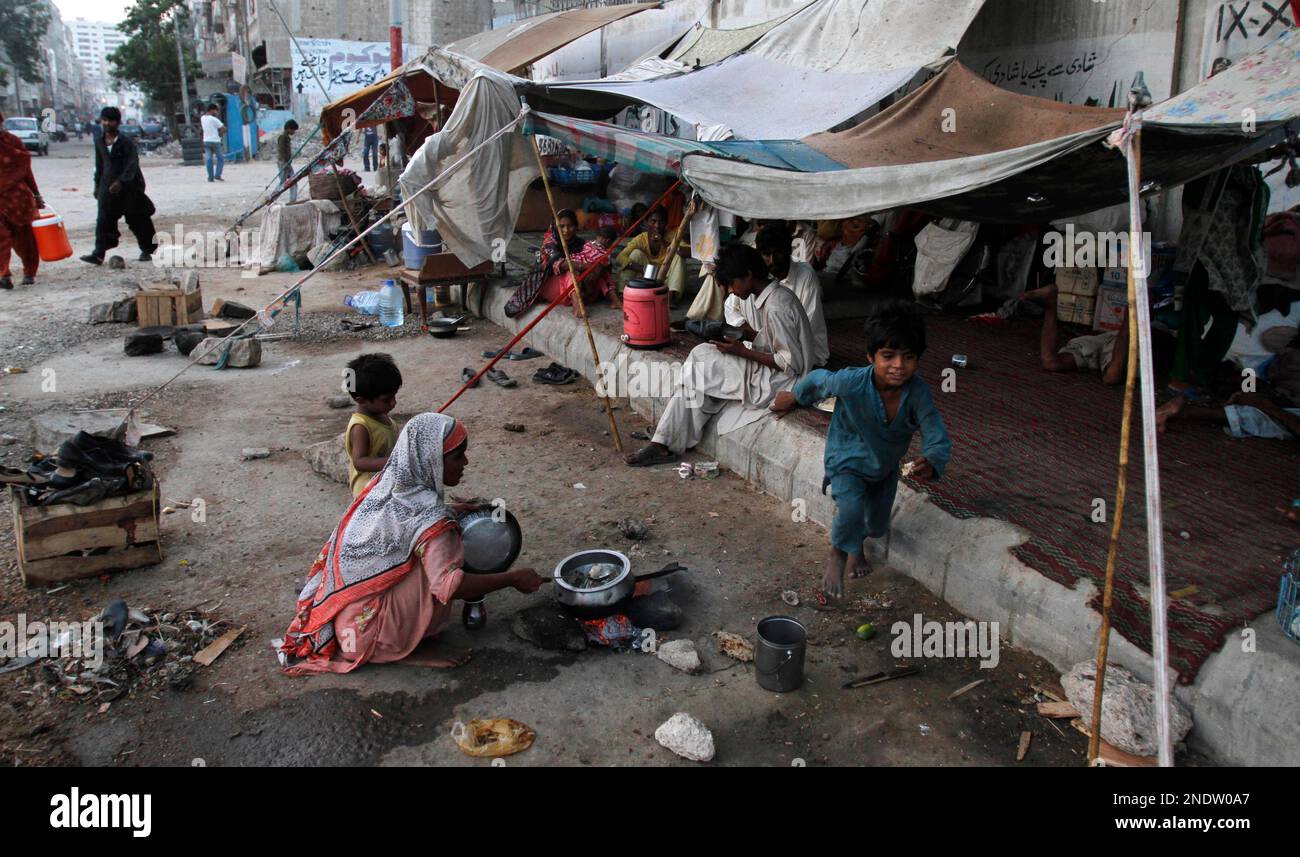 Pakistani families, living in make-shift homes, are seen in a slum in ...