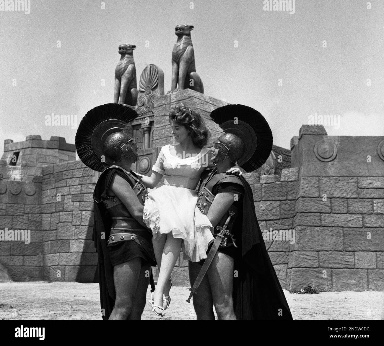 Hollywood actress Tina Louise is carried by two helmeted ancient ...