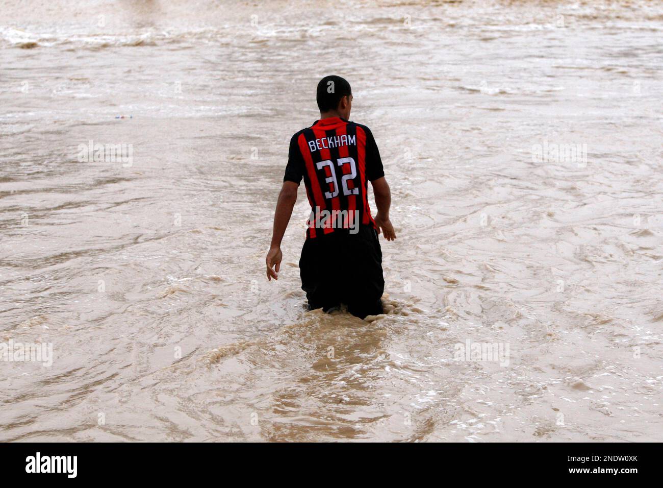A Saudi man walks through a flooded street after a rainstorm in Riyadh ...