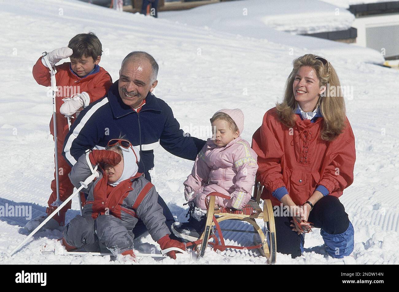 King Hussein with his family are shown sledding in 1985. King Hussein, Queen Nur, Princess Iman ...