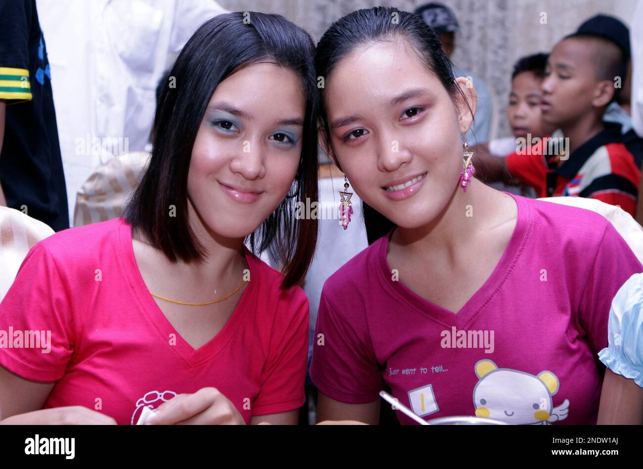 Myanmar's famous twin sisters Aye Aye Nyein, left, and Ei Ei Nyein, who were born as conjoined ...