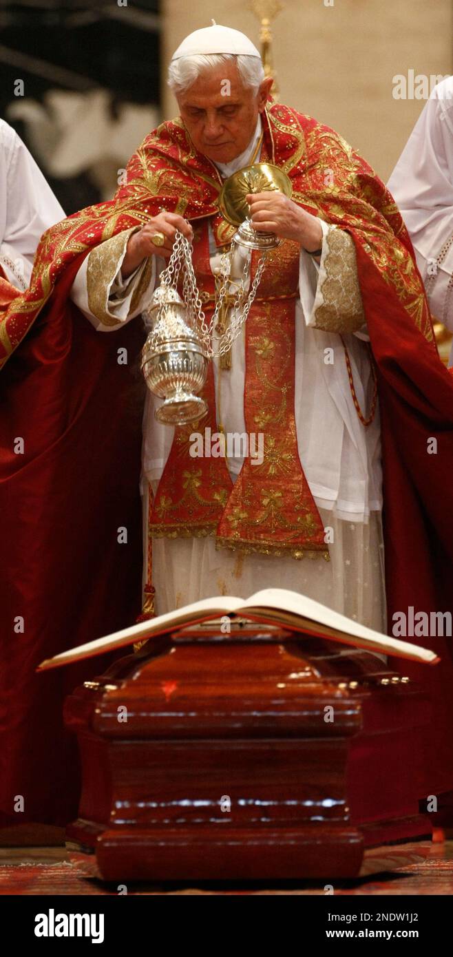 Pope Benedict XVI disperses incense on the coffin of late German ...