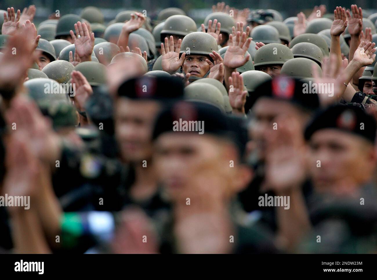 Filipino troopers raise their hands as a religious leader recites a ...