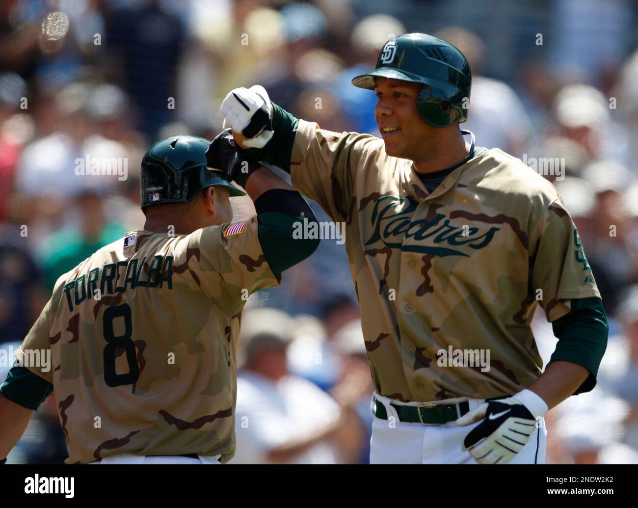 San Diego Padres' Kyle Blanks, riight, bashes forearms with Yorvit ...