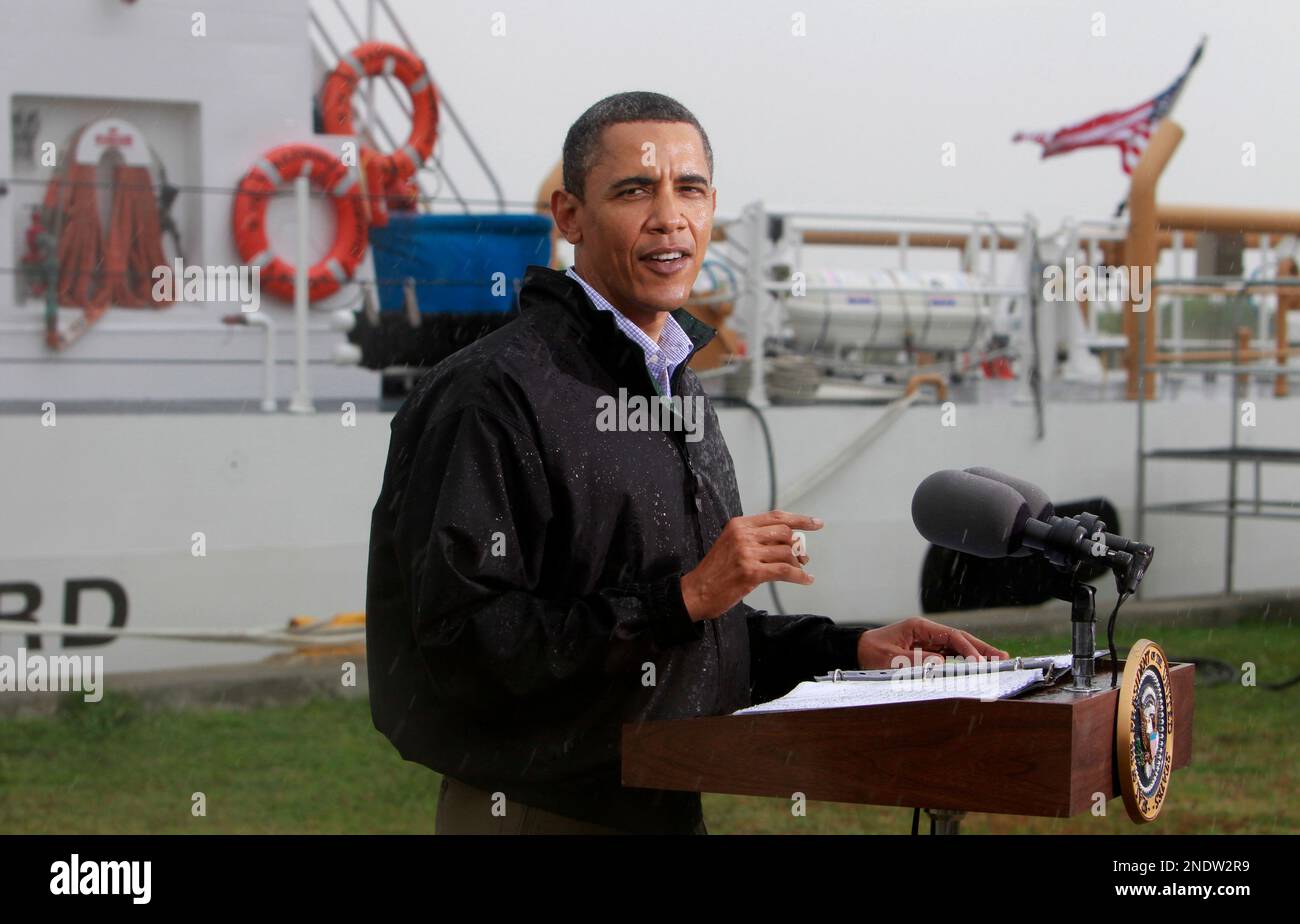 President Barack Obama, standing in the rain, makes a statement to ...