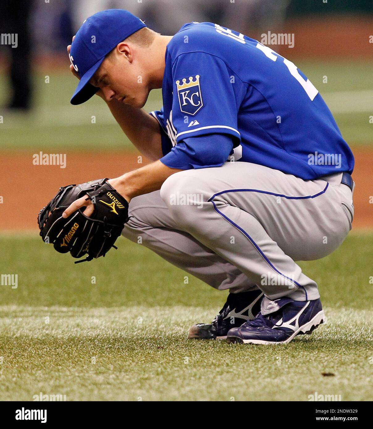Kansas City Royals starting pitcher Zack Greinke reacts after hitting ...